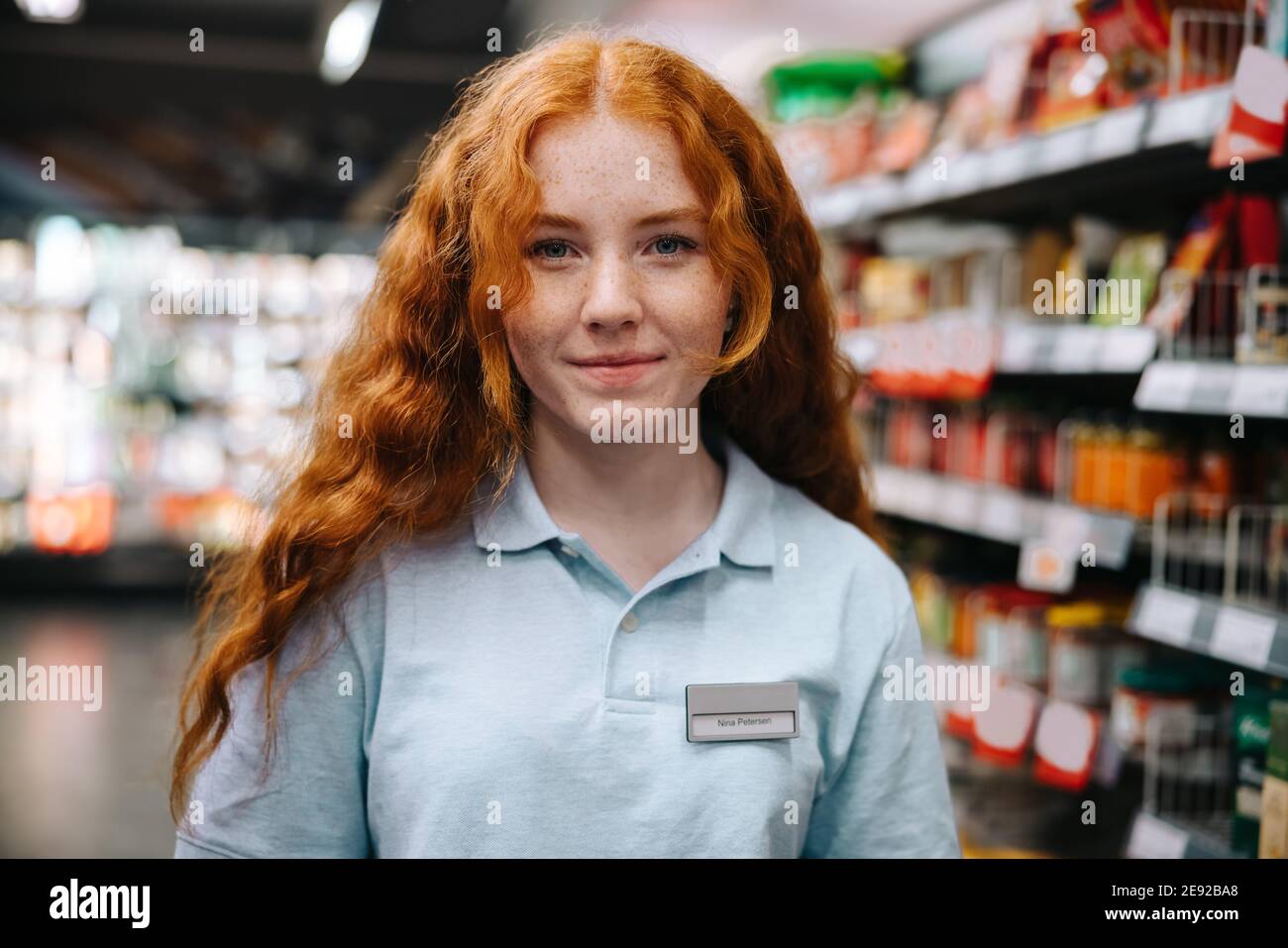 Portrait of a young female worker working in the grocery store. Woman ...