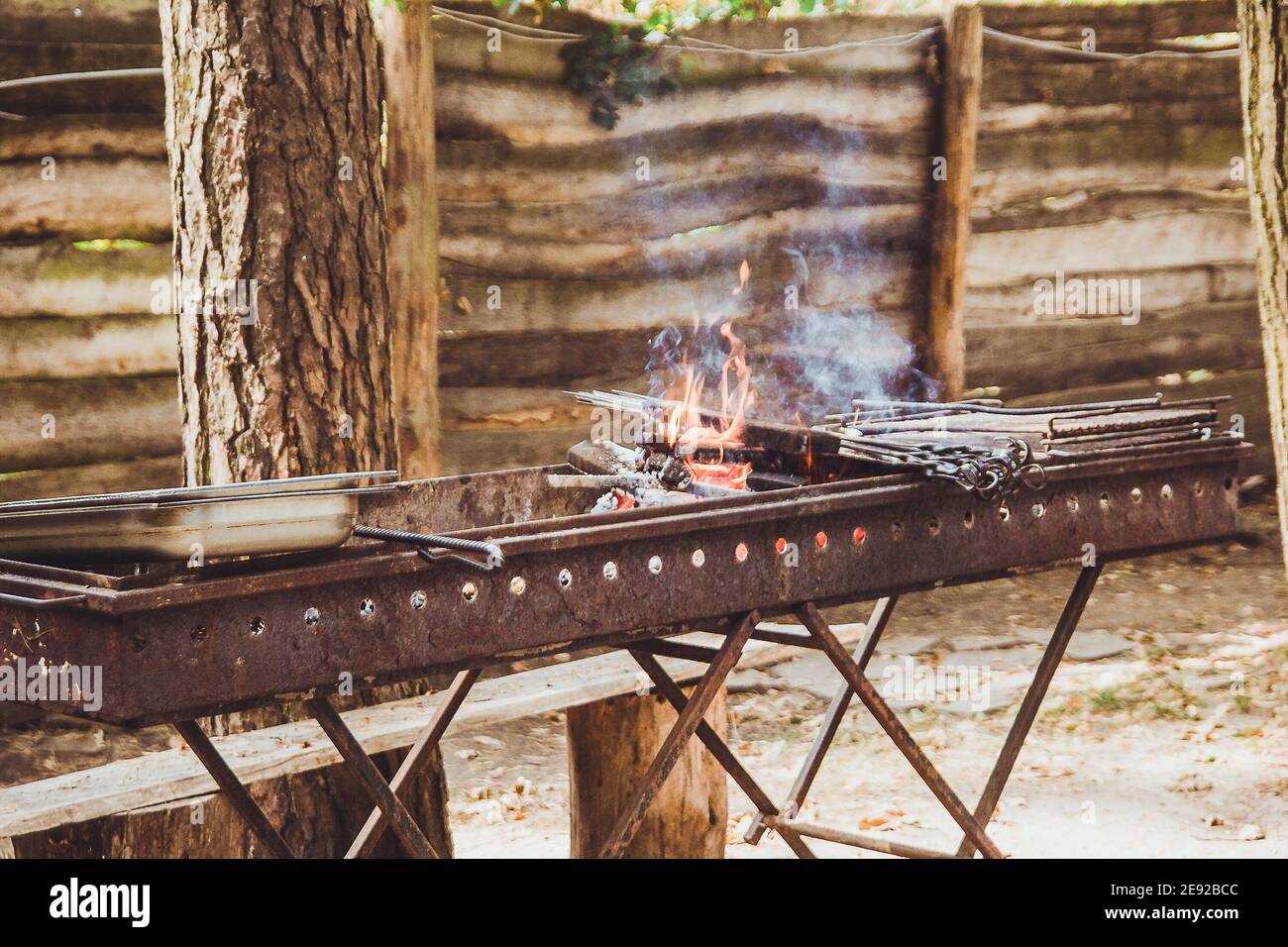 A folding portable brazier filled with burning wood Stock Photo - Alamy