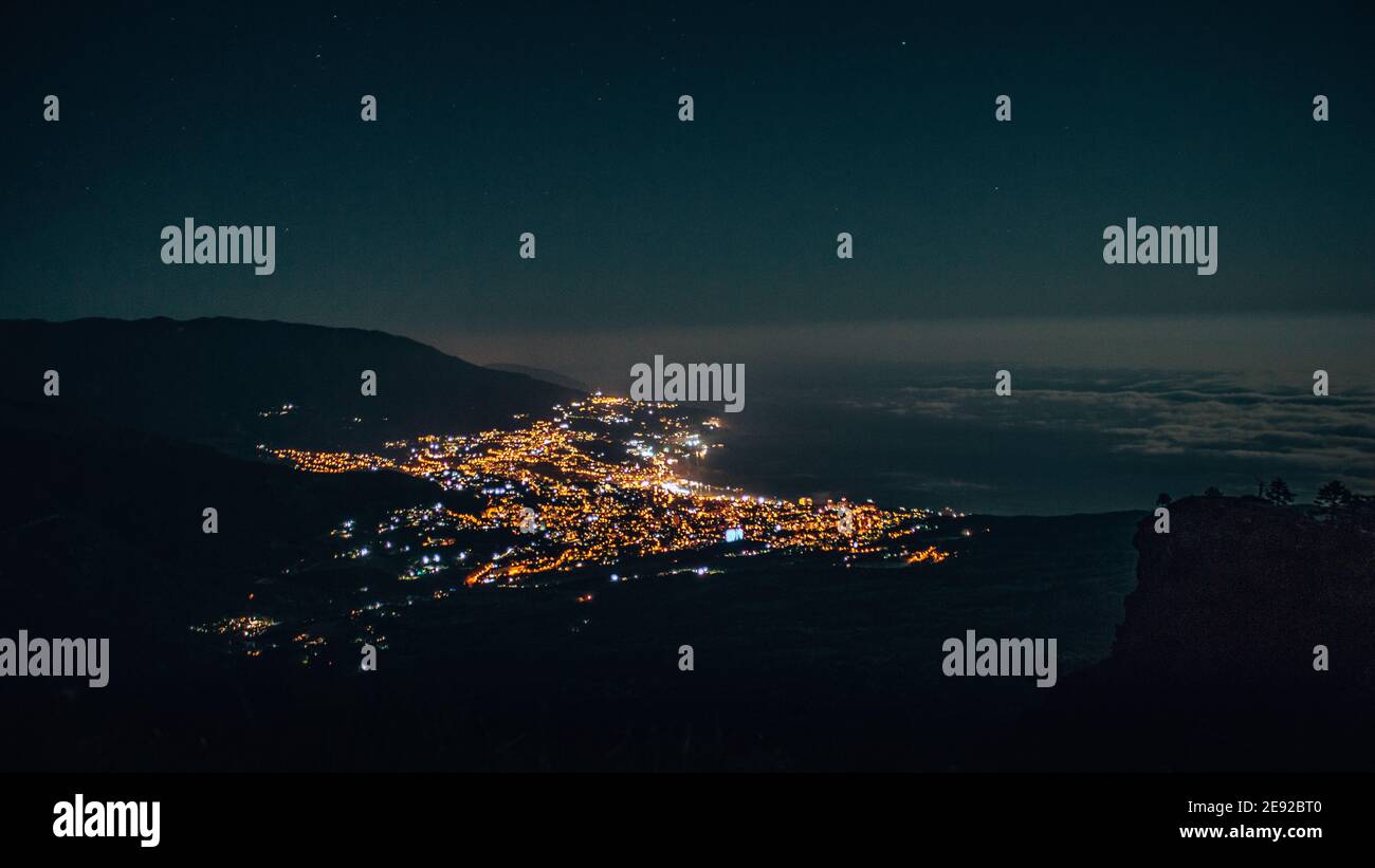 Night town with a small illumination of buildings near a shore Stock ...