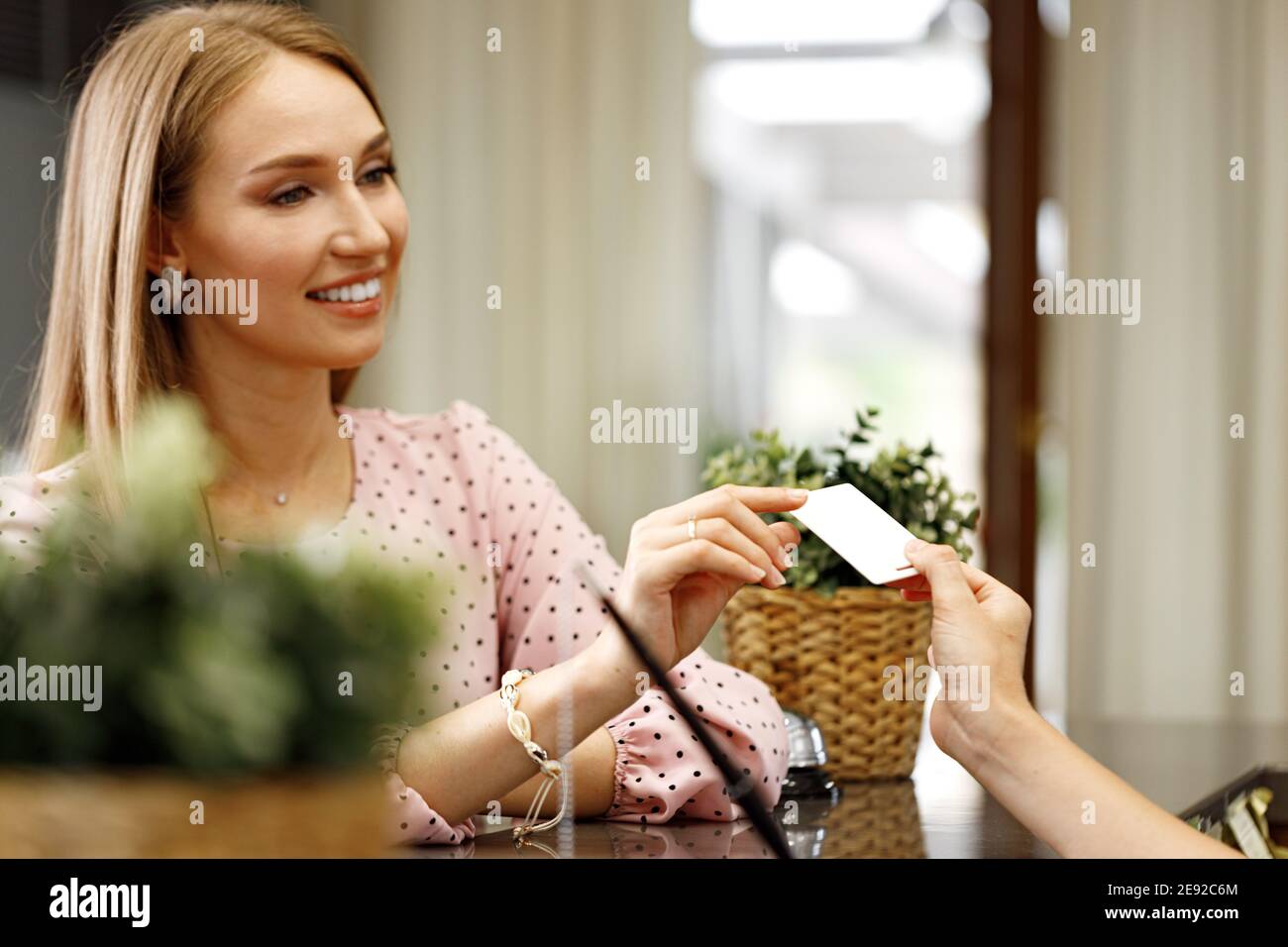 Woman receiving door key in hotel front desk Stock Photo - Alamy