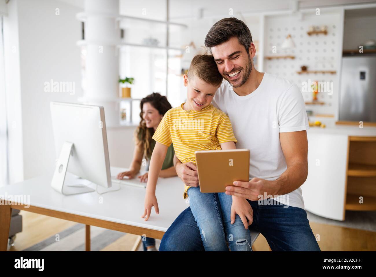 Parents helping to children studying online at home. Lockdown and ...