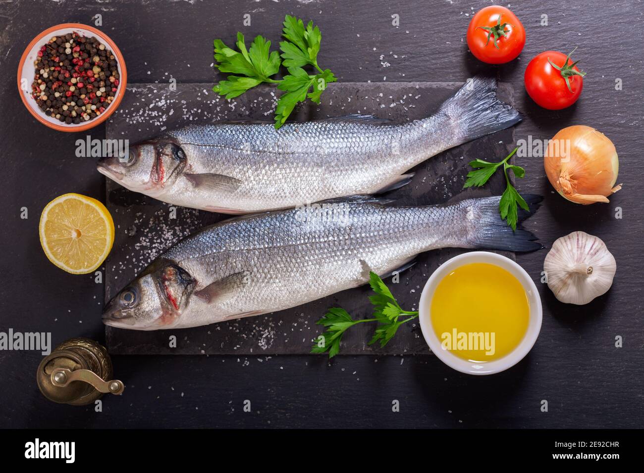 fresh fish with ingredients for cooking dark background, top view Stock ...