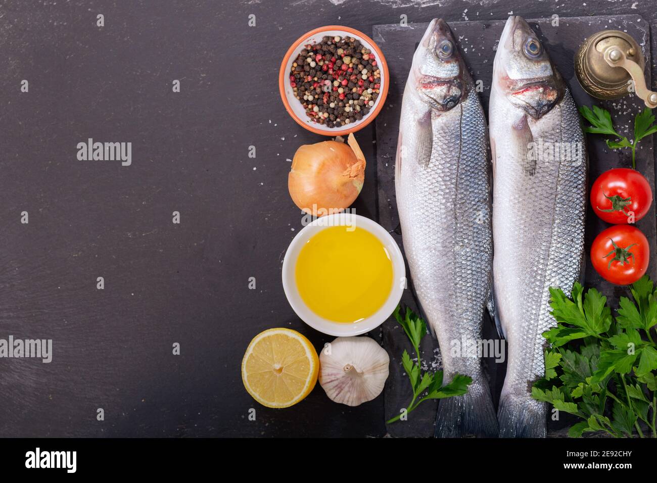 fresh fish with ingredients for cooking dark background, top view Stock ...