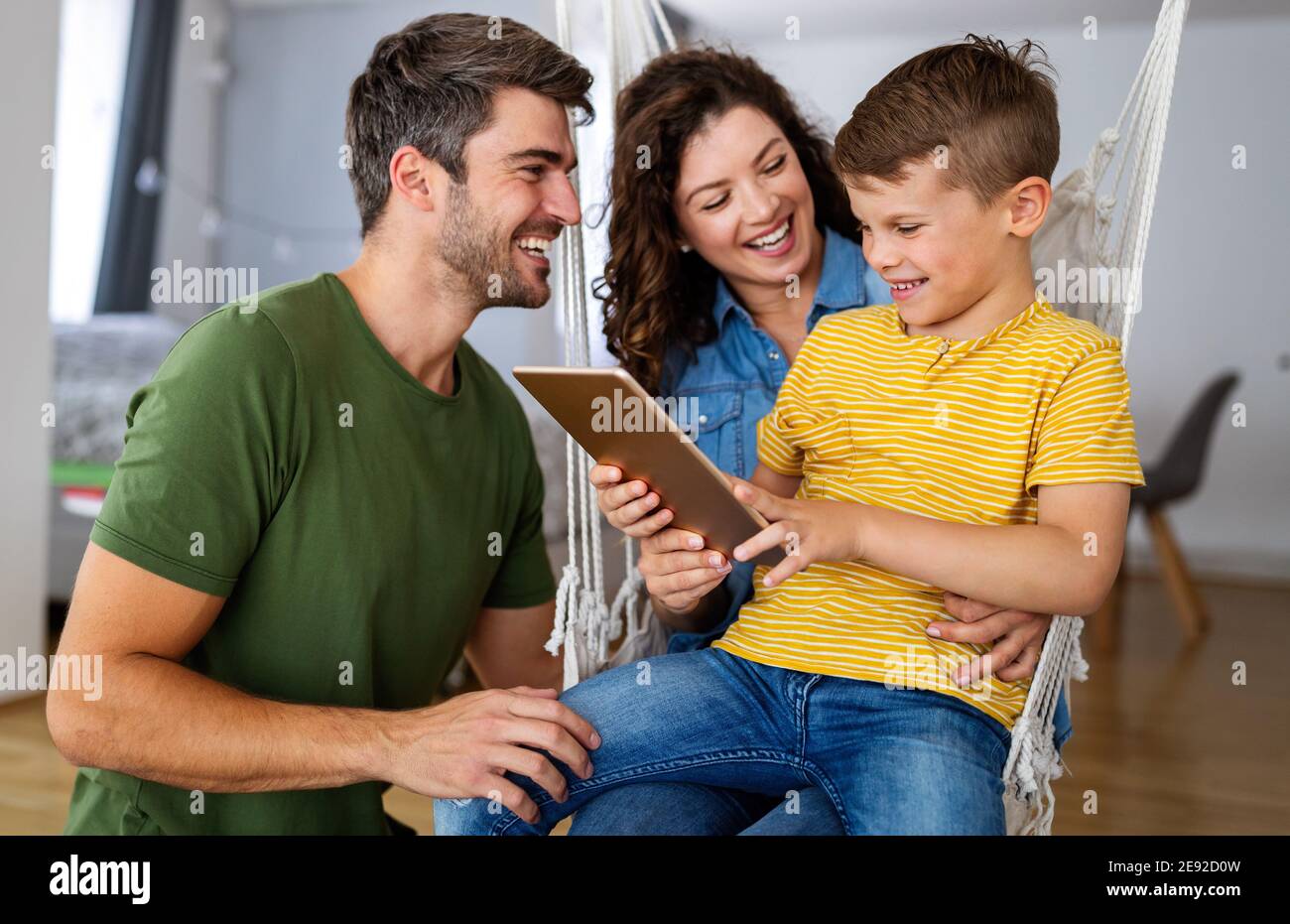 Happy family using technology devices together at home Stock Photo - Alamy