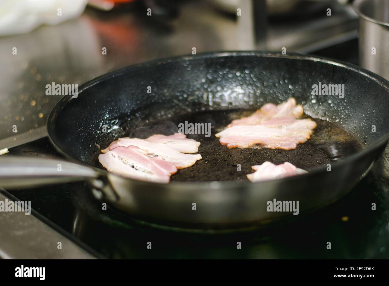 Chef preparing breakfast with eggs and bacon at a restaurant Stock ...