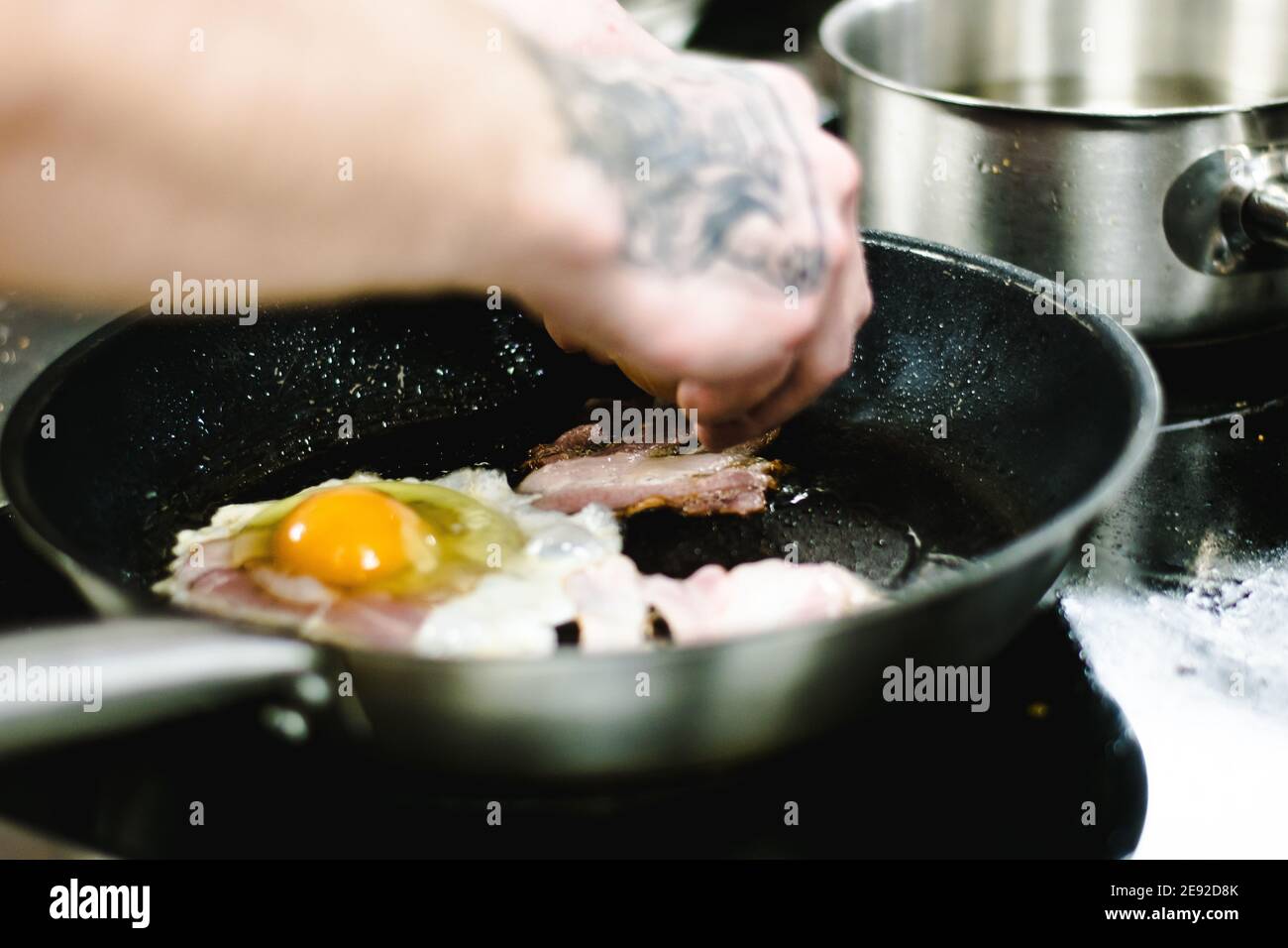 Chef preparing breakfast with eggs and bacon at a restaurant Stock ...