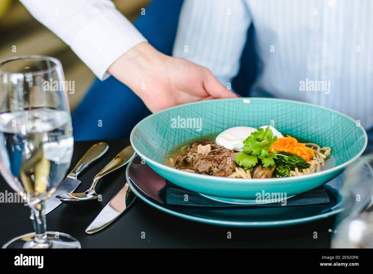 Beef ramen soup with poached egg and vegetables at a restaurant Stock ...
