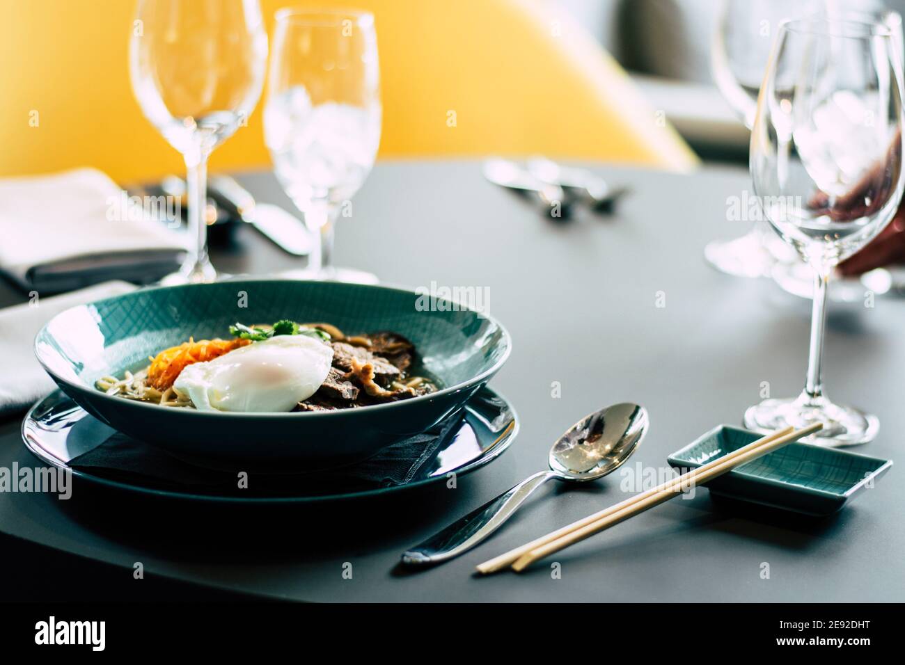 Beef ramen soup with poached egg and vegetables at a restaurant Stock ...