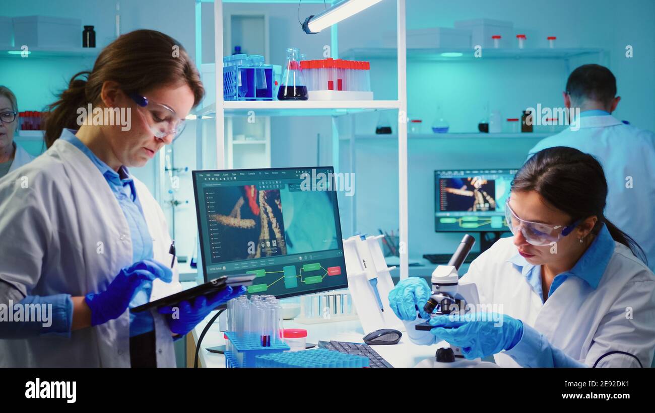 Nurses analysing together virus mutations working overtime in chemistry ...