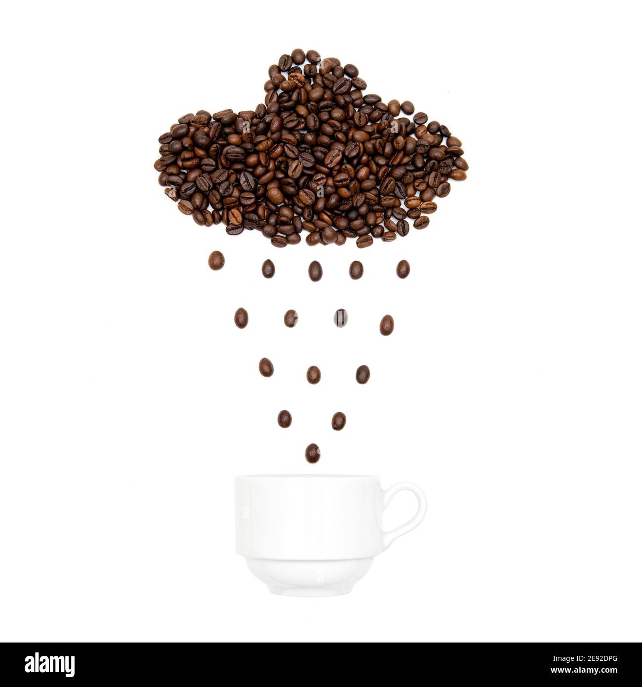 Rain cloud made of roasted coffee beans pouring over a white cup ...
