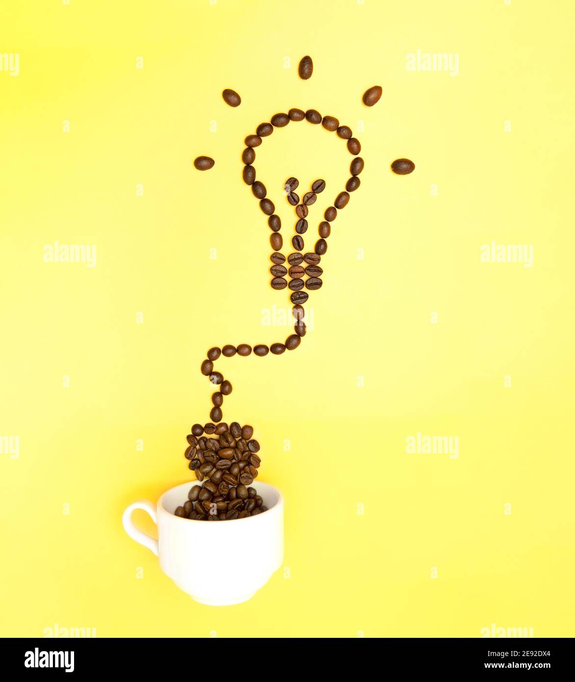 Creative arrangement of roasted coffee beans resembling a glowing light ...