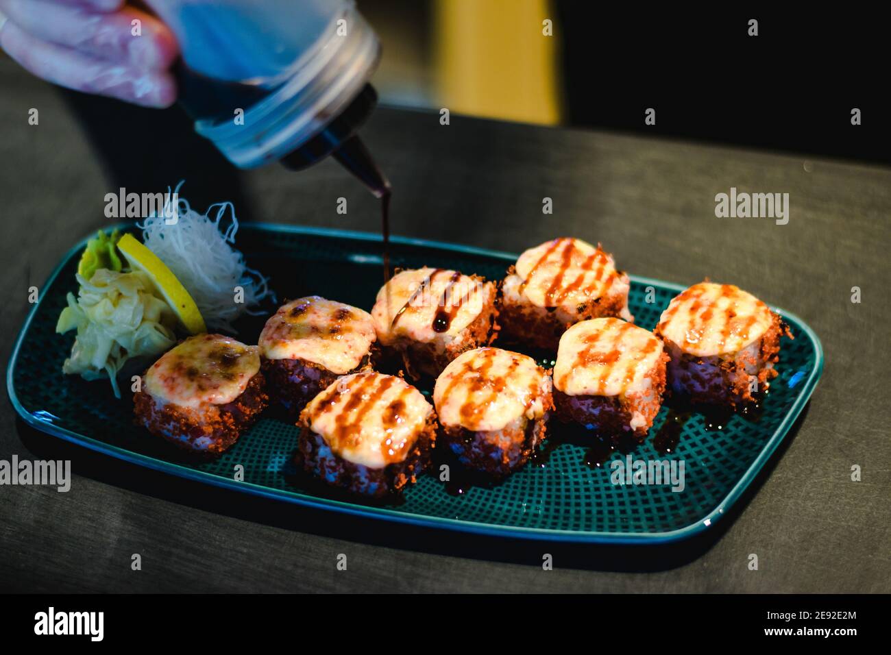 Sushi chef making maki and sashimi sushi at a sushi restaurant Stock ...