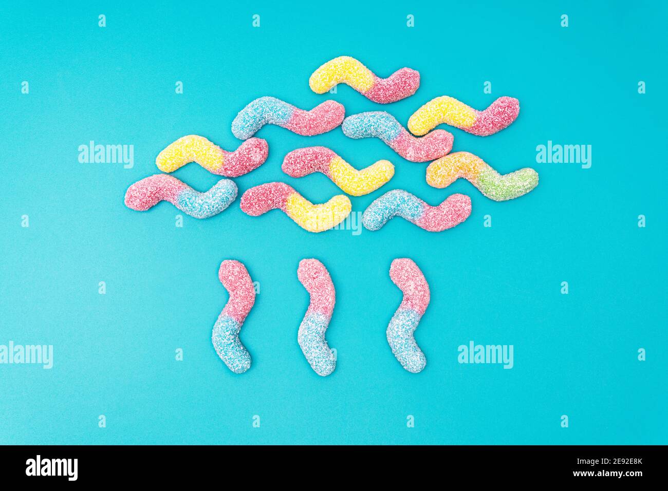 Creative raining cloud flat lay made of colored sugar coated gummy ...
