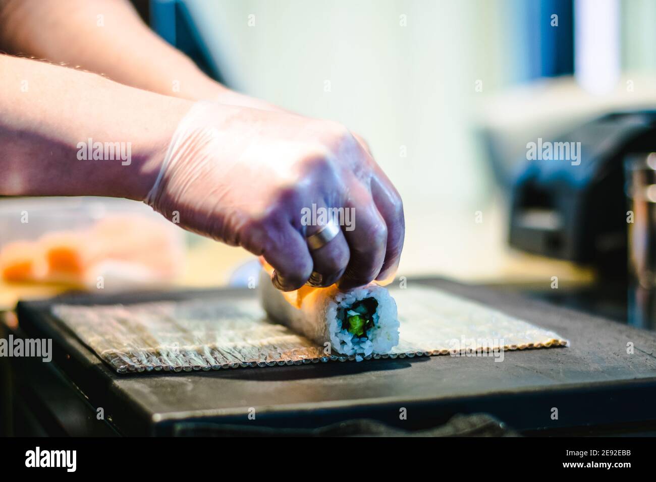 Sushi chef making maki and sashimi sushi at a sushi restaurant Stock ...