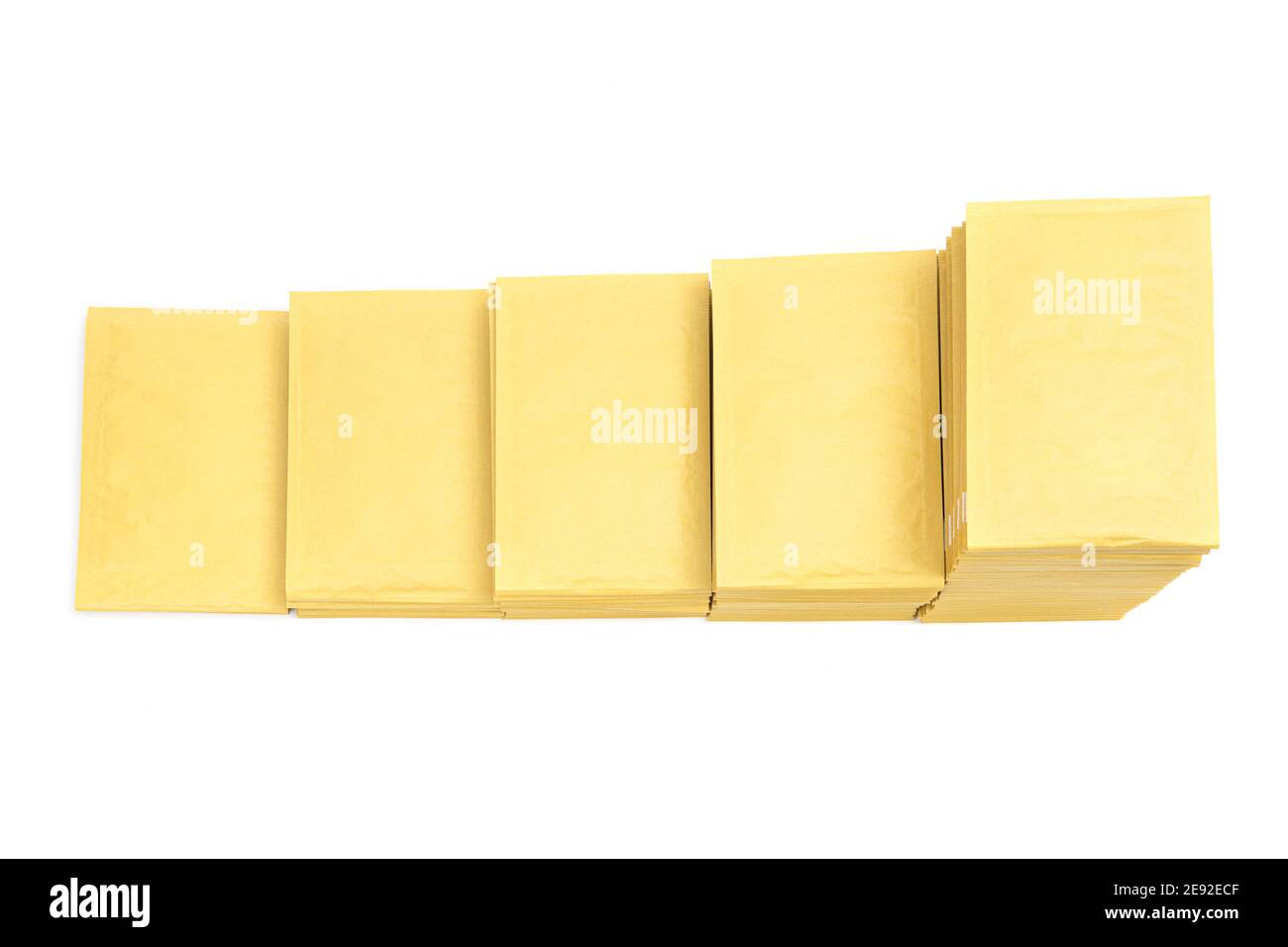 Top view of five stacks of yellow mail envelopes arranged in line in ...