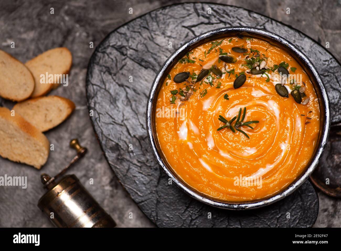 Pumpkin soup in a bowl on a rustic setup with food ingredients Stock ...