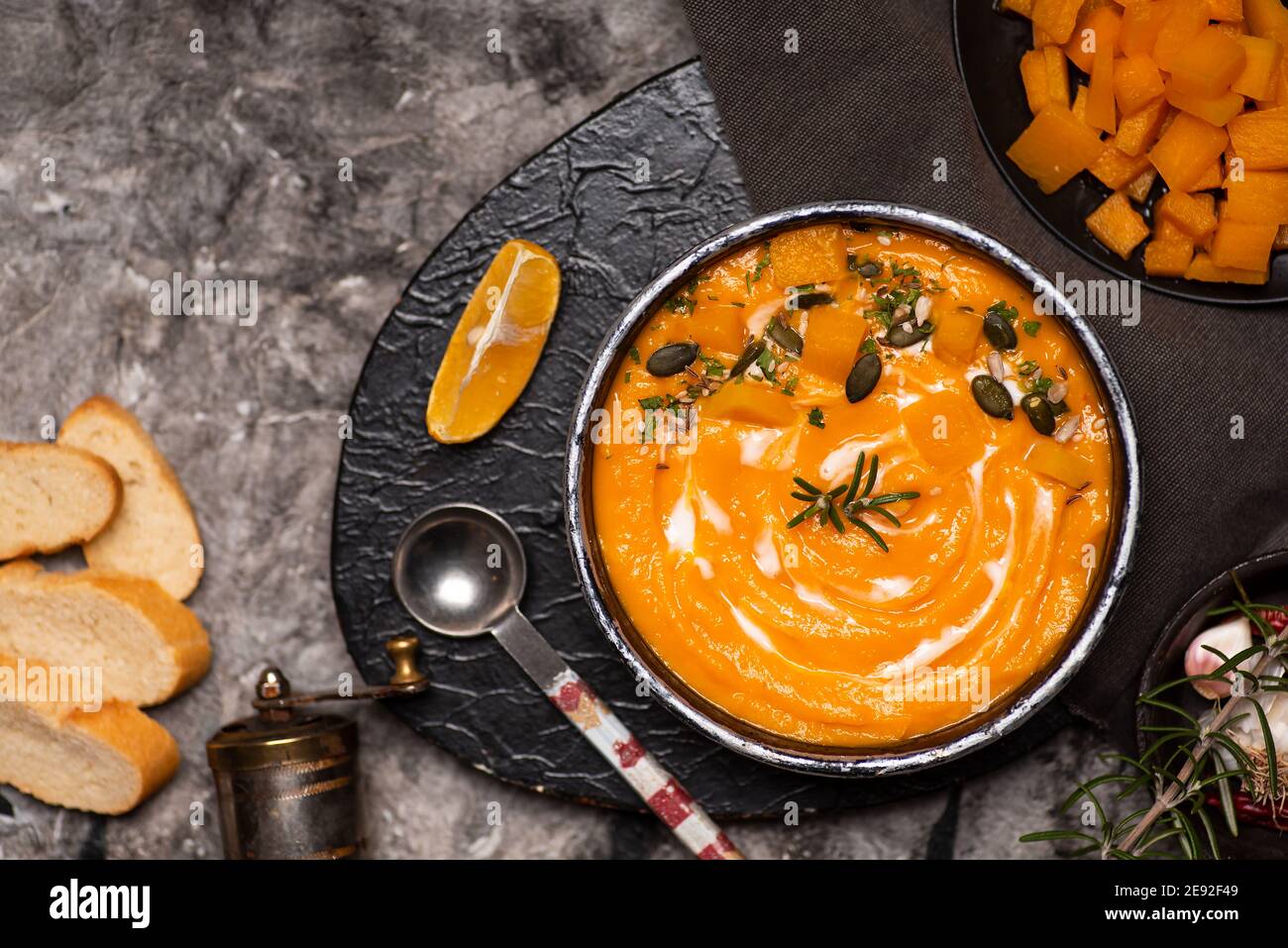 Pumpkin soup in a bowl on a rustic setup with food ingredients Stock ...