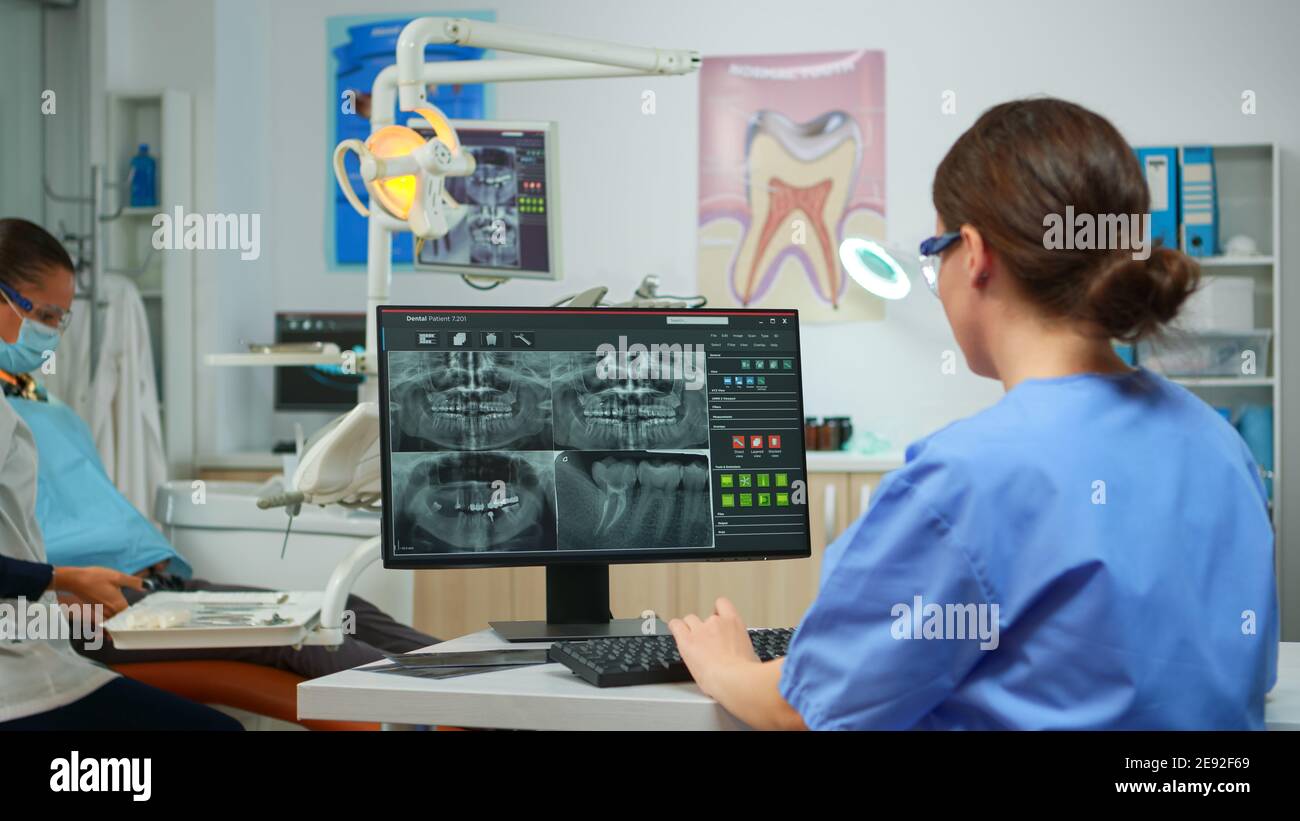 Dentistry doctor explaining to patient the dental process of ...