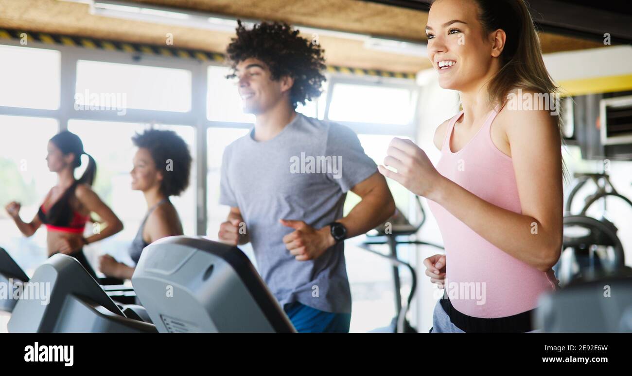 Group of people exercising in a gym cardio training and running Stock ...