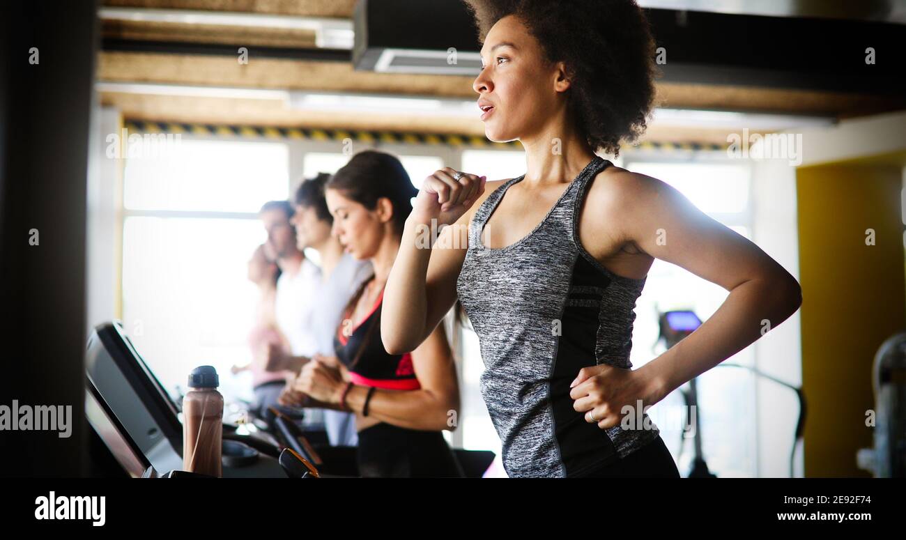Group of fit healthy friends people cardio workout in gym Stock Photo ...