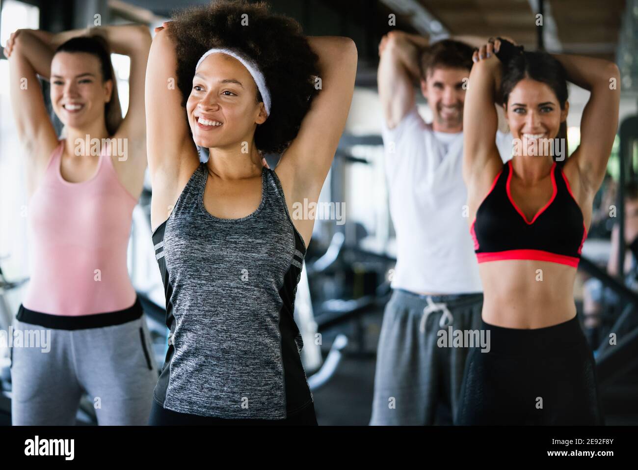 Beautiful fit people exercising together in gym Stock Photo - Alamy