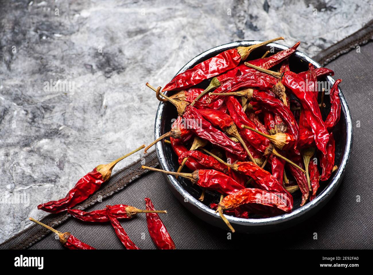 Dry red peppers on a stone table top view Stock Photo - Alamy
