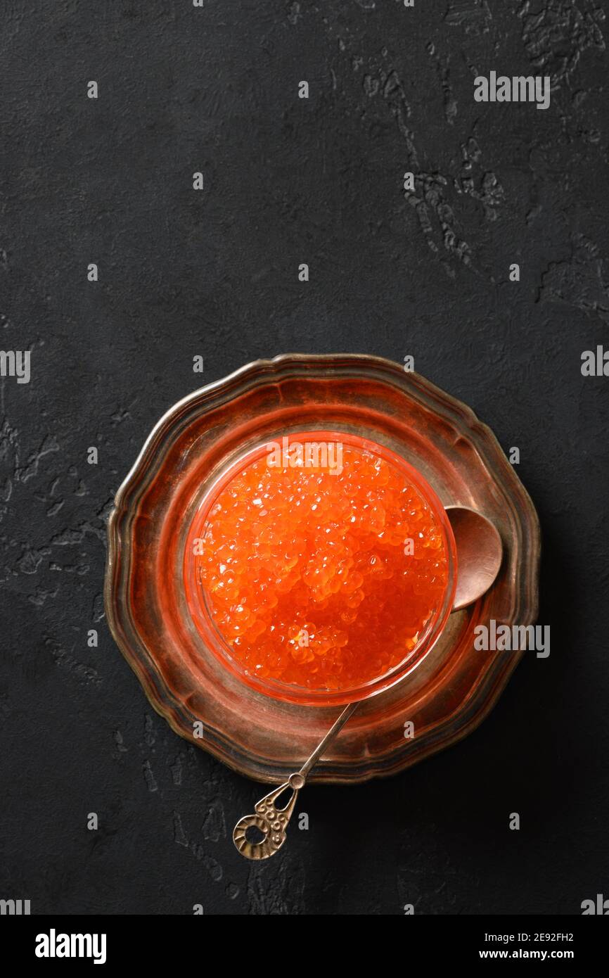 Red caviar on black background. Space for text. Vertical format Stock ...