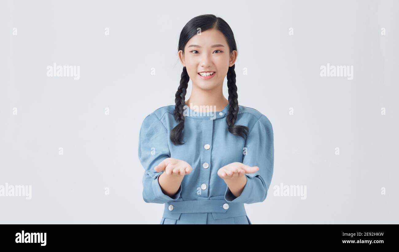 young excited woman standing happy smiling holding her hand showing ...