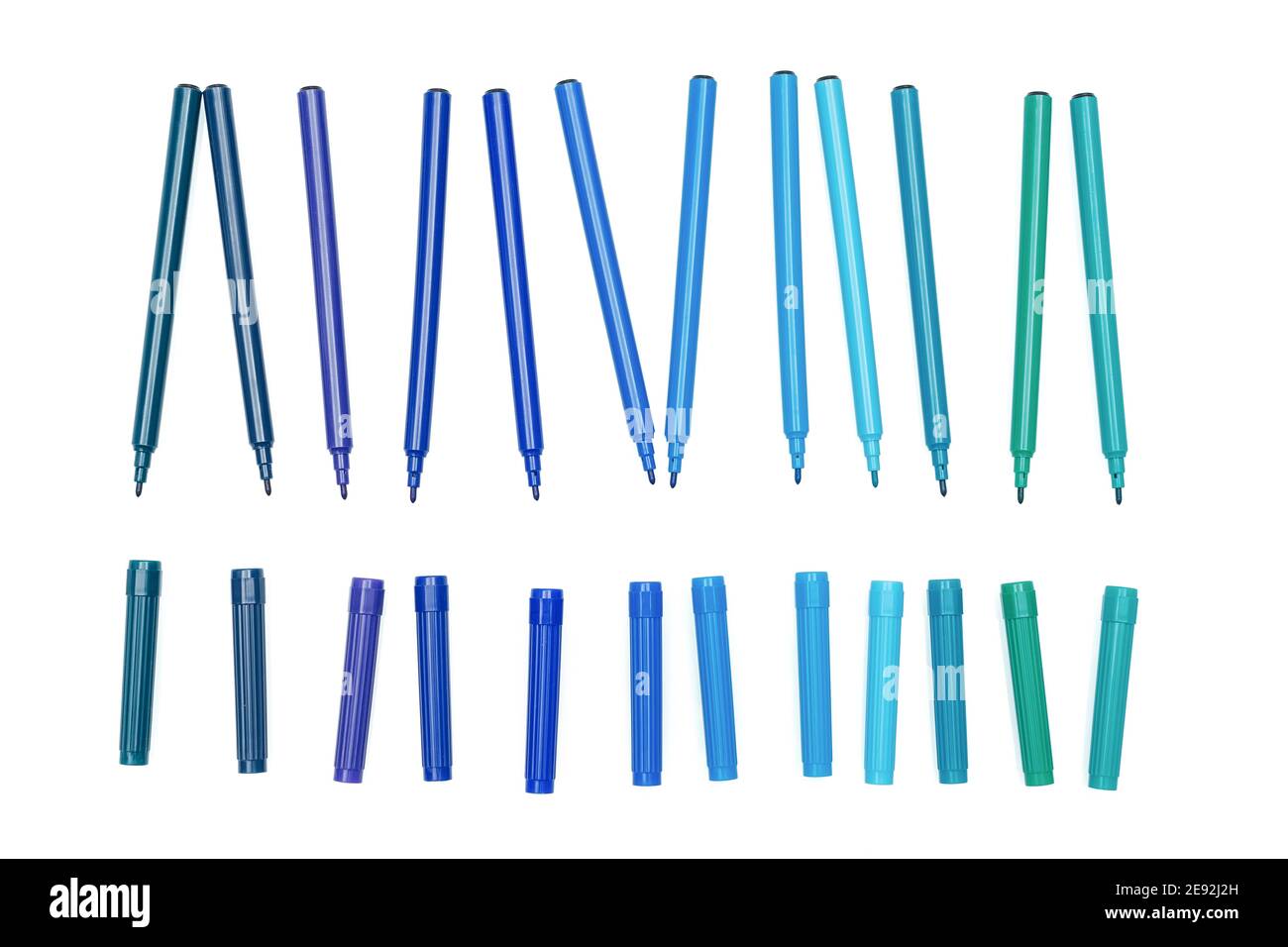 Various of blue colored markers pens with cap off on isolated ...