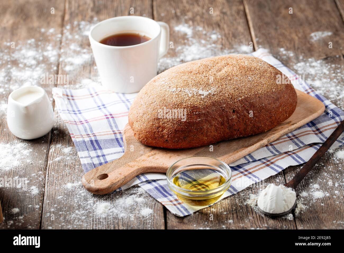 Side view on gray loaf of bread with olive oil Stock Photo - Alamy