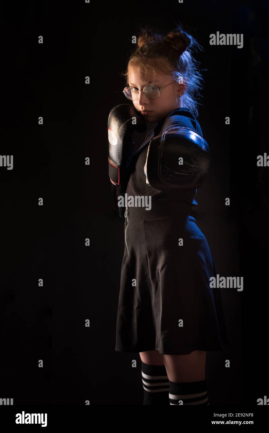 The girl hits the front jab. A girl in boxing gloves hits a straight ...