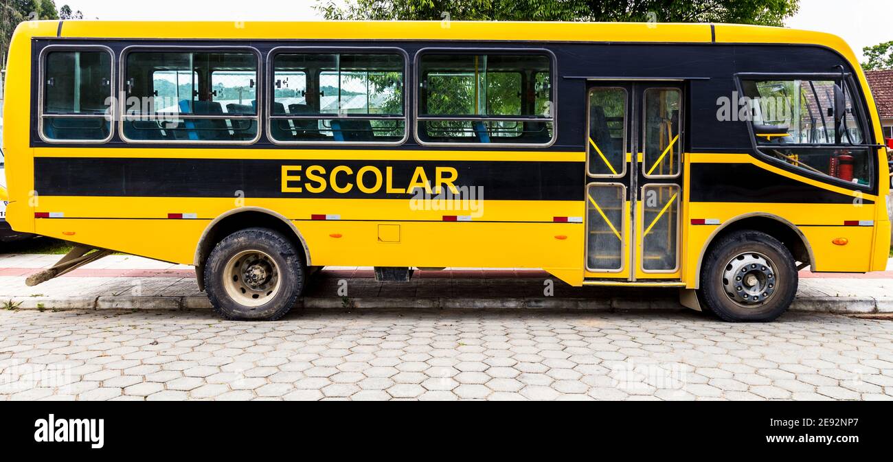 Yellow school bus parked on pavement street in Brazil Stock Photo - Alamy