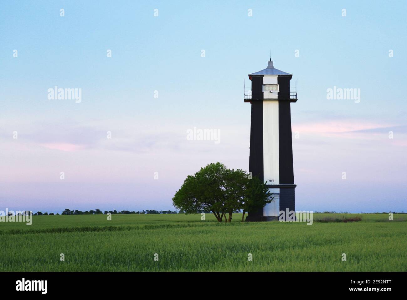 Lighthouse building. Old black and white lighthouse building stands on ...