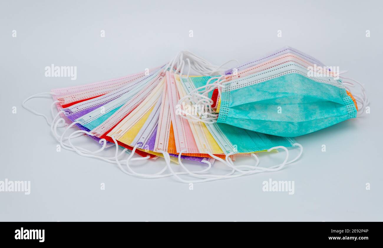 colored medical masks on a white background. sterile bandages on the ...