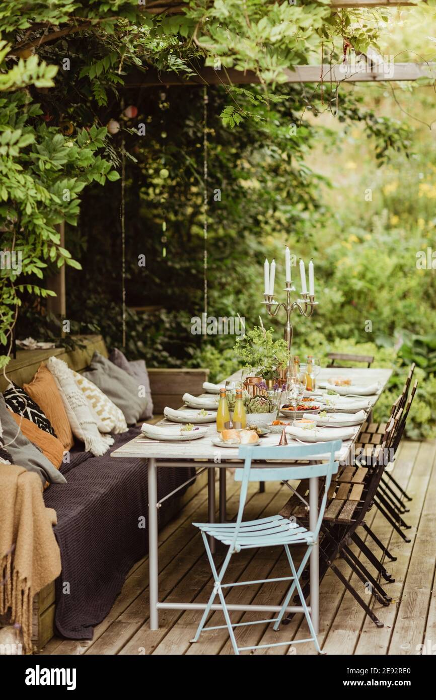 Table ready for dinner party at back yard Stock Photo - Alamy