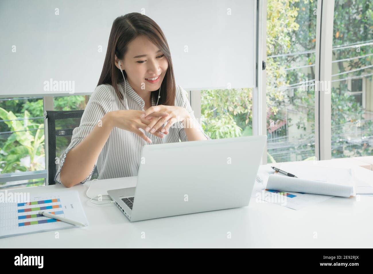 Business employee using laptop for video conferencing with colleagues ...