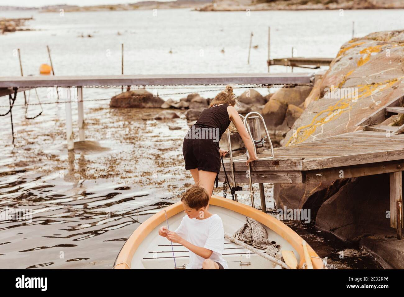 Mother and son in boat at harbor during vacation Stock Photo - Alamy