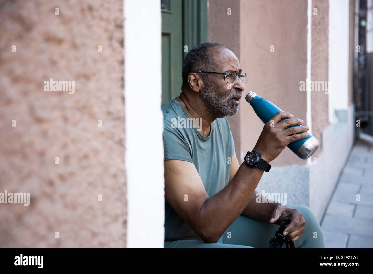 Senior man drinking water sitting hi-res stock photography and images ...