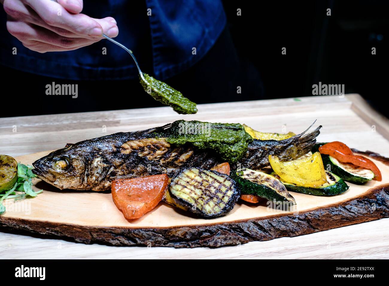 Fried fish on a wood plate at a restaurant Stock Photo - Alamy