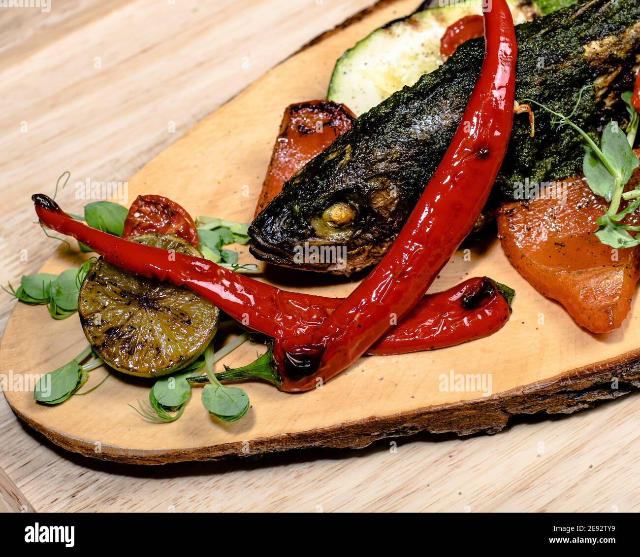 Fried fish on a wood plate at a restaurant Stock Photo - Alamy