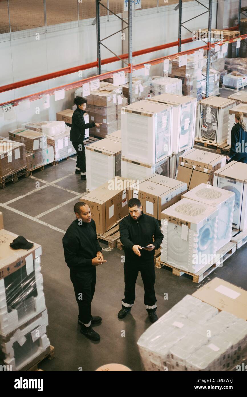 High angle view of manual workers working in logistics warehouse Stock ...