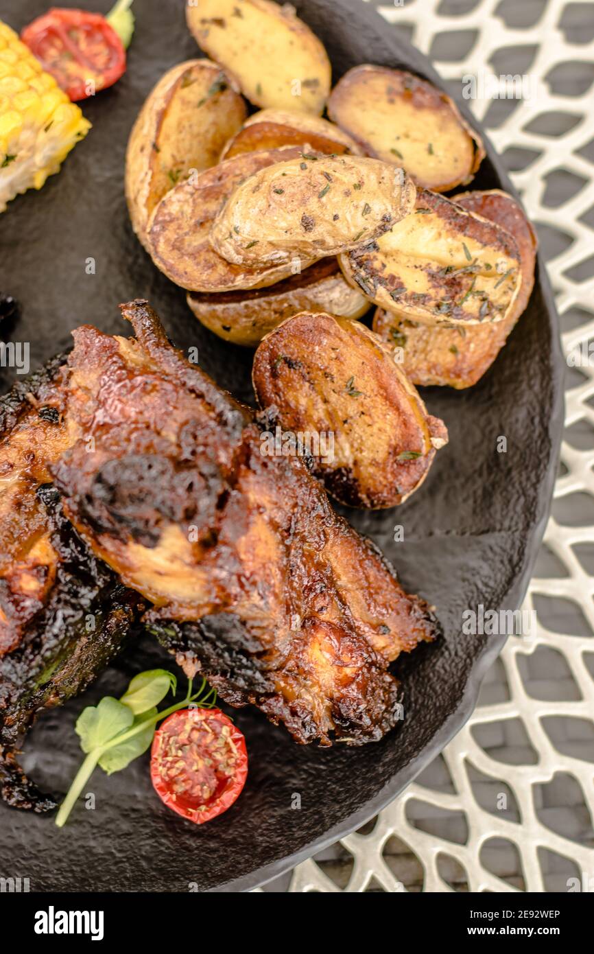 Fried ribs witch sauce and vegetables prepared at a restaurant Stock ...
