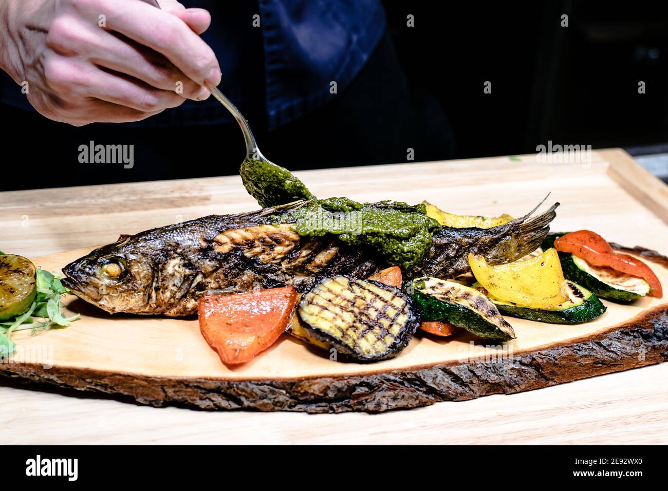 Fried fish on a wood plate at a restaurant Stock Photo - Alamy