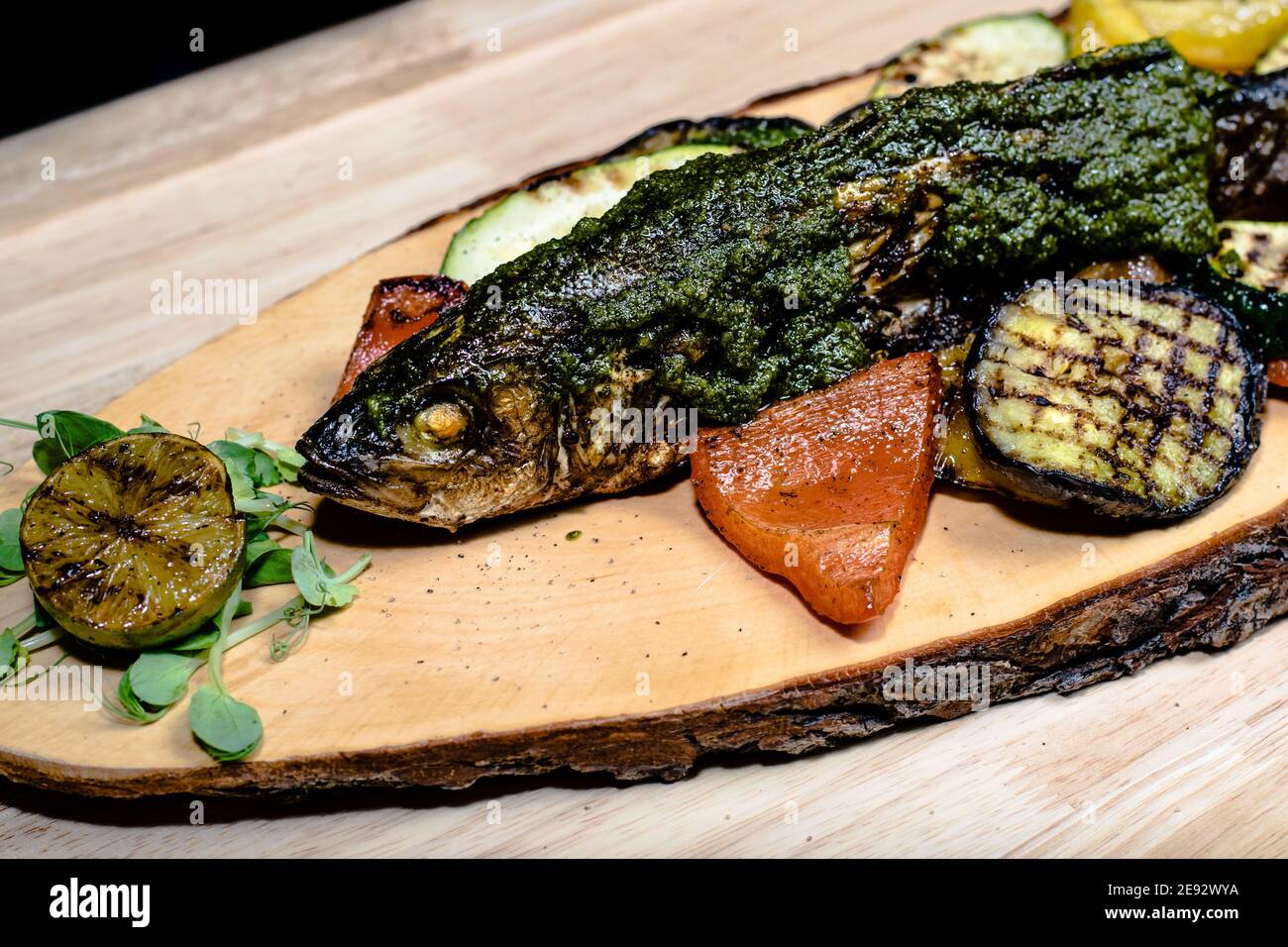 Fried fish on a wood plate at a restaurant Stock Photo - Alamy