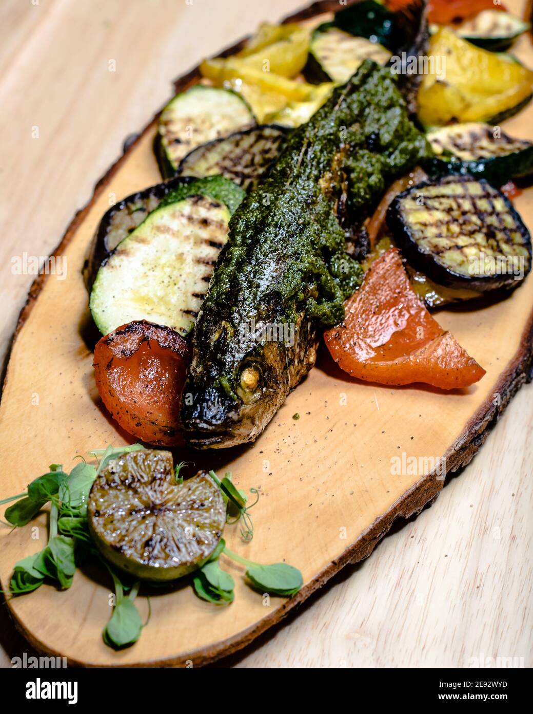 Fried fish on a wood plate at a restaurant Stock Photo - Alamy