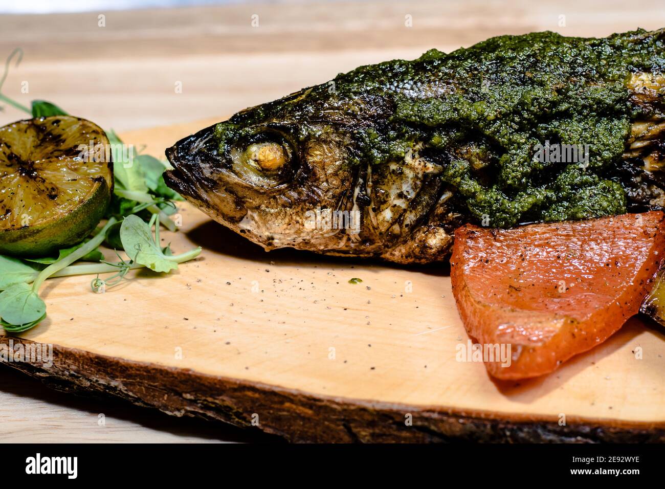 Fried fish on a wood plate at a restaurant Stock Photo - Alamy