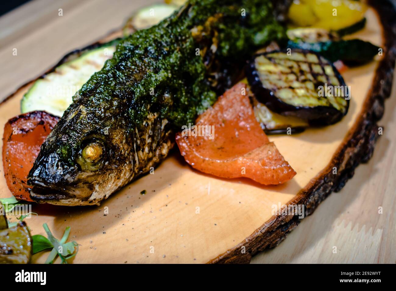 Fried fish on a wood plate at a restaurant Stock Photo - Alamy