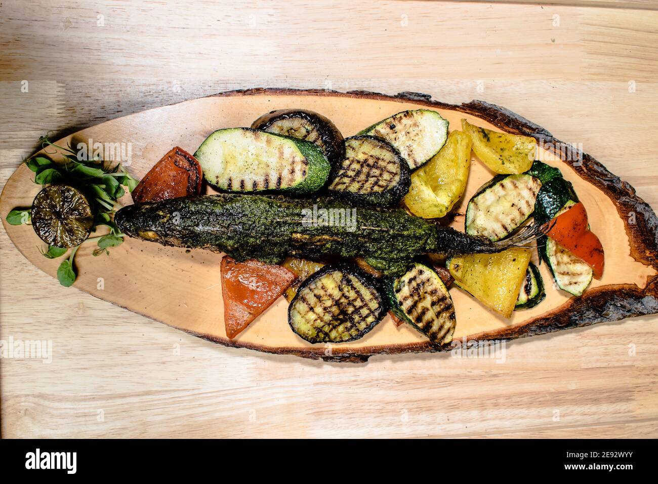 Fried fish on a wood plate at a restaurant Stock Photo - Alamy