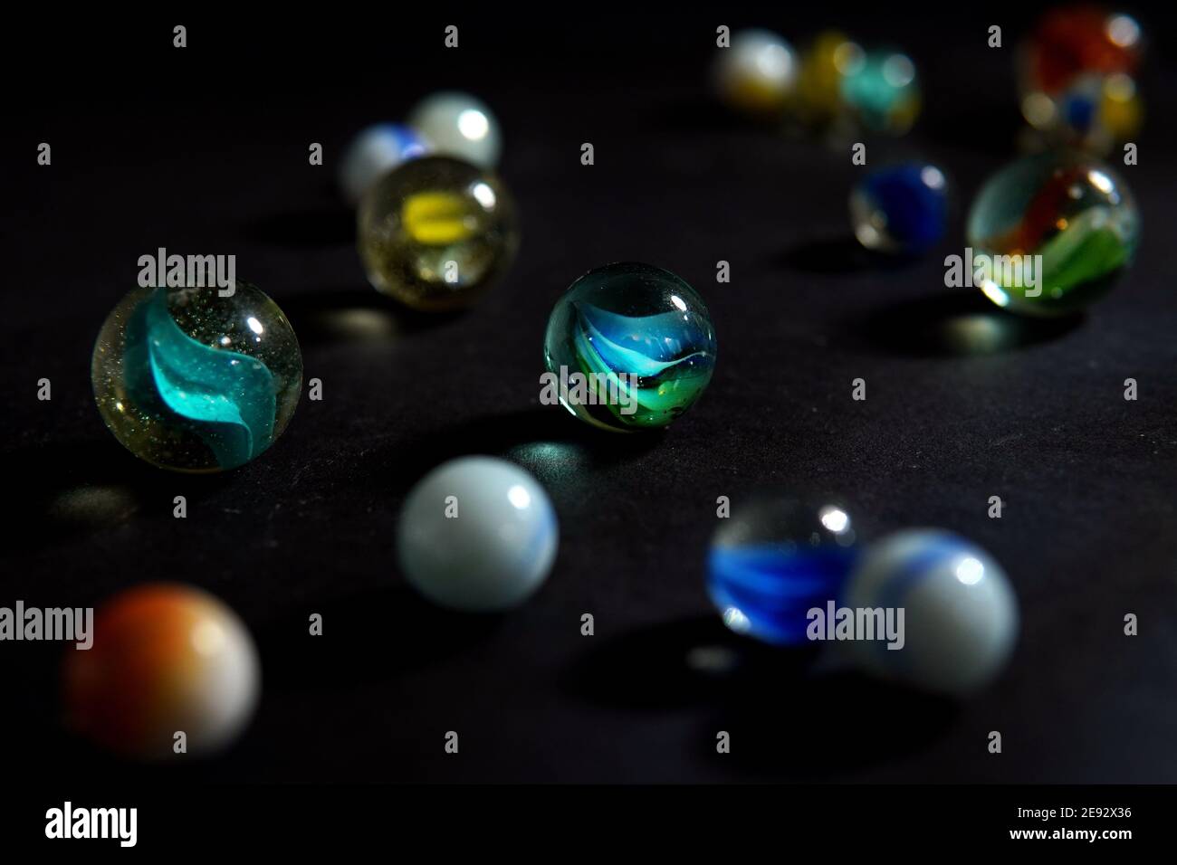Colorful marbles with scattered swirl marbles on dark background Stock ...