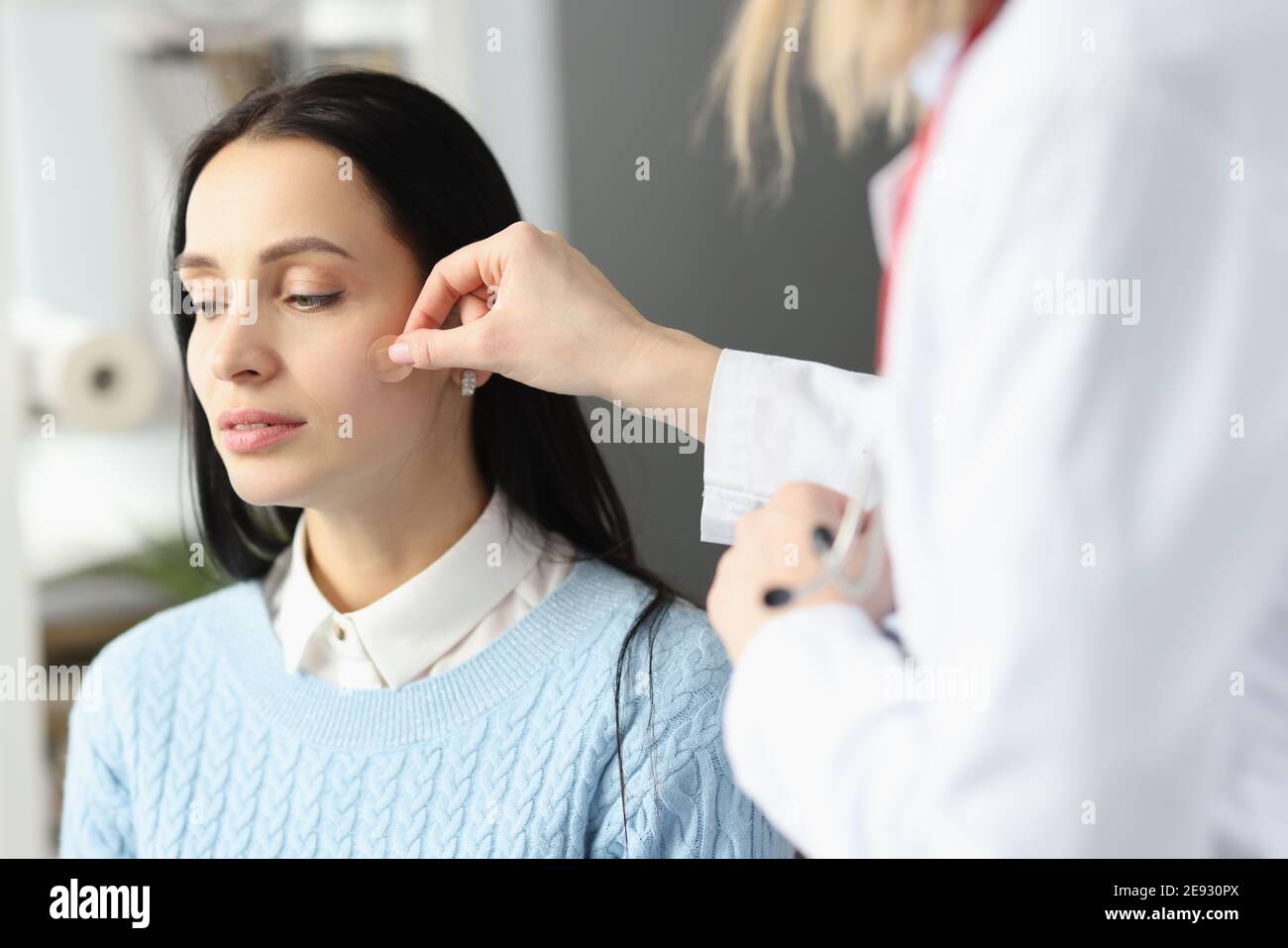 Doctor sticking adhesive plaster on patients face Stock Photo - Alamy